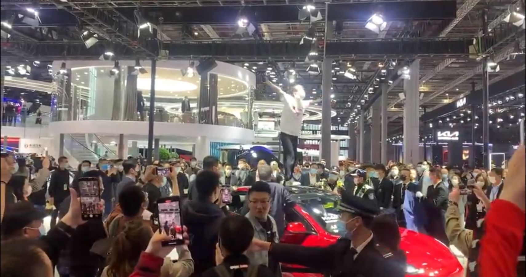 Furious Tesla Owner Protests At Shanghai Auto Show From Model 3s Roof